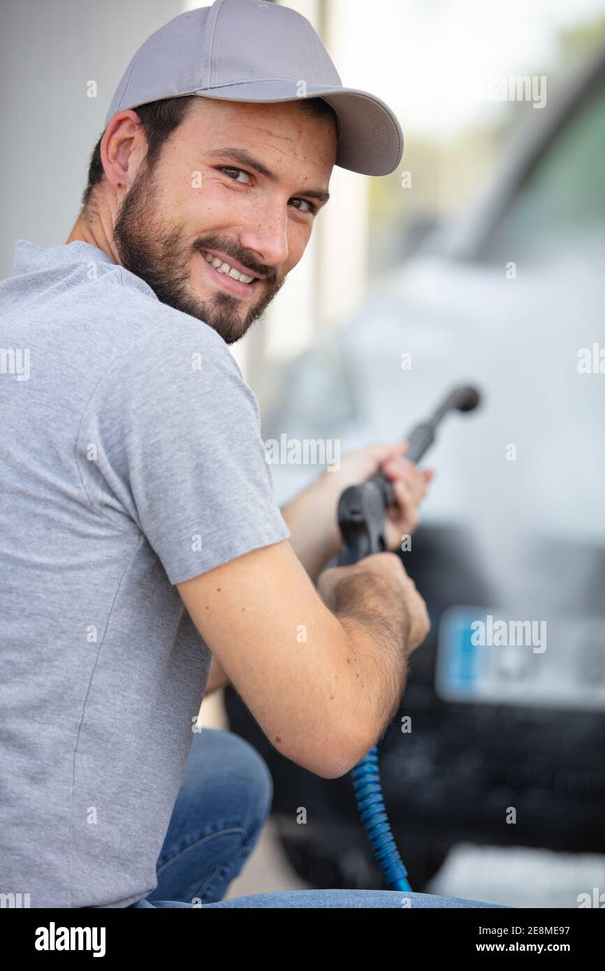man cleaning car with a spray hose Stock Photo - Alamy
