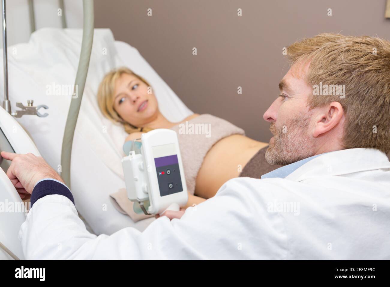 doctor performing obstetric ultrasonography on a pregnant woman Stock ...