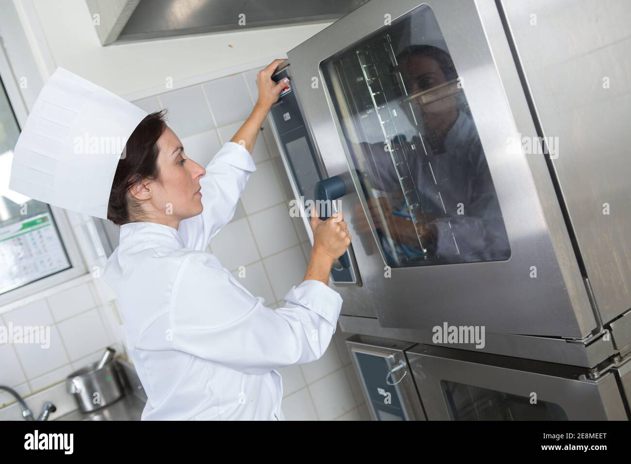 Serious woman cooking stove hi-res stock photography and images - Alamy