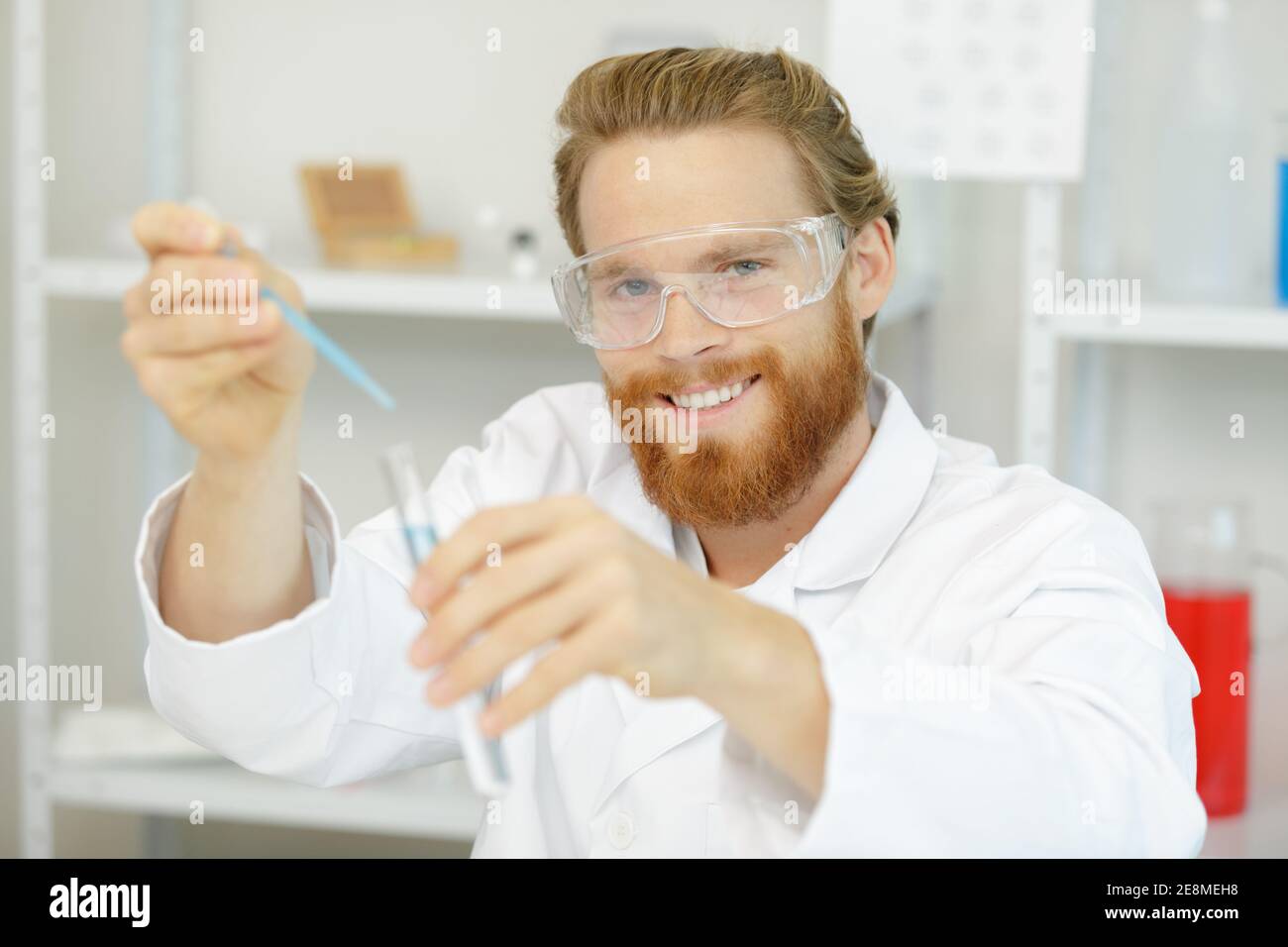 male worker smiling in lab Stock Photo - Alamy