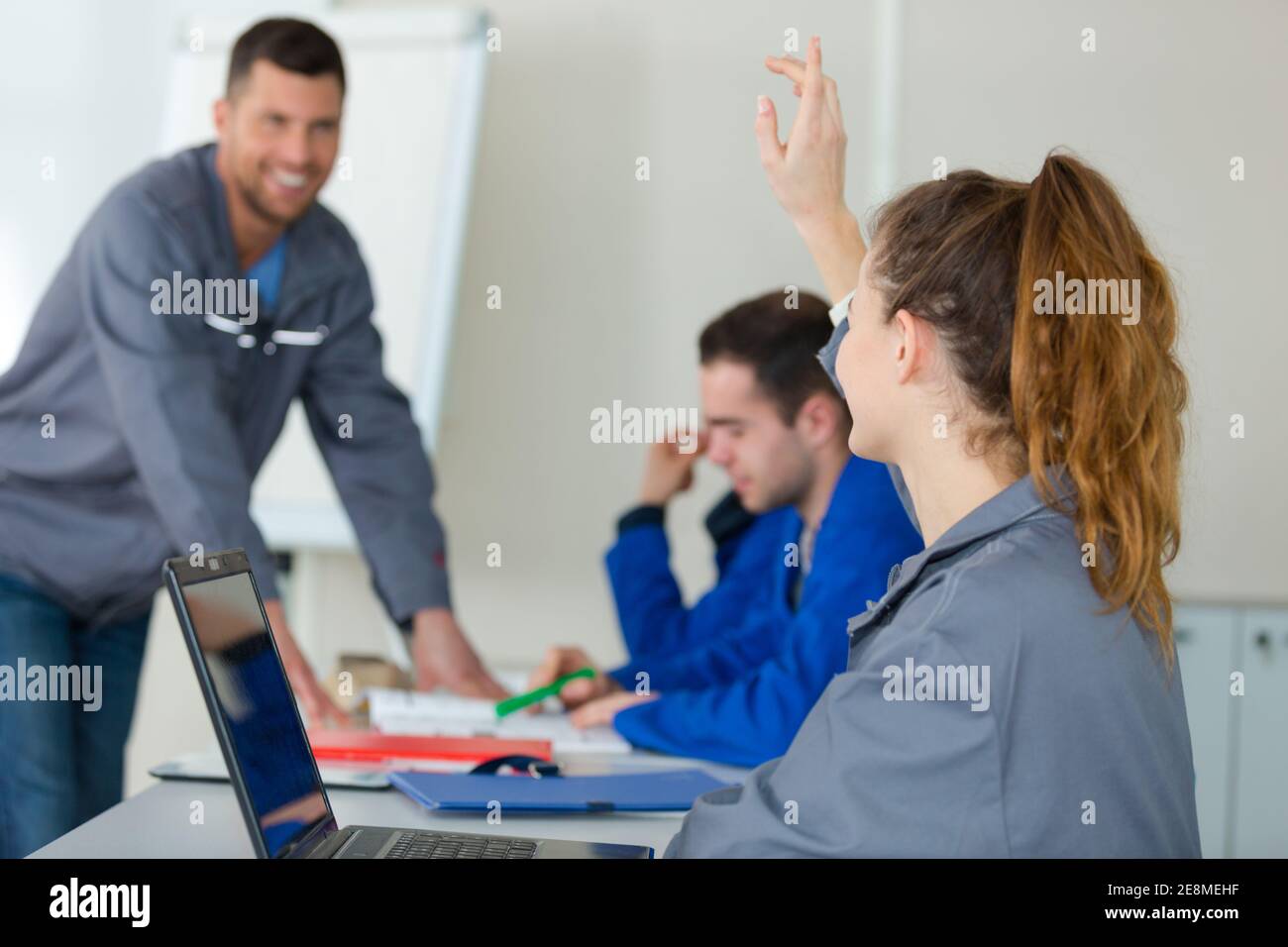 student lifting hand in class Stock Photo - Alamy