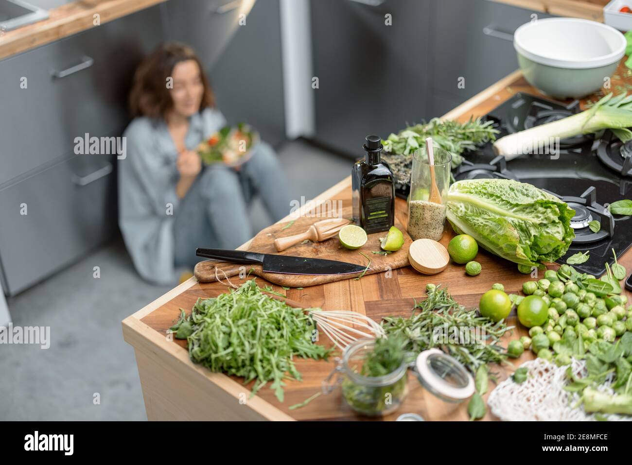 Healthy food on kitchen with woman on background Stock Photo - Alamy