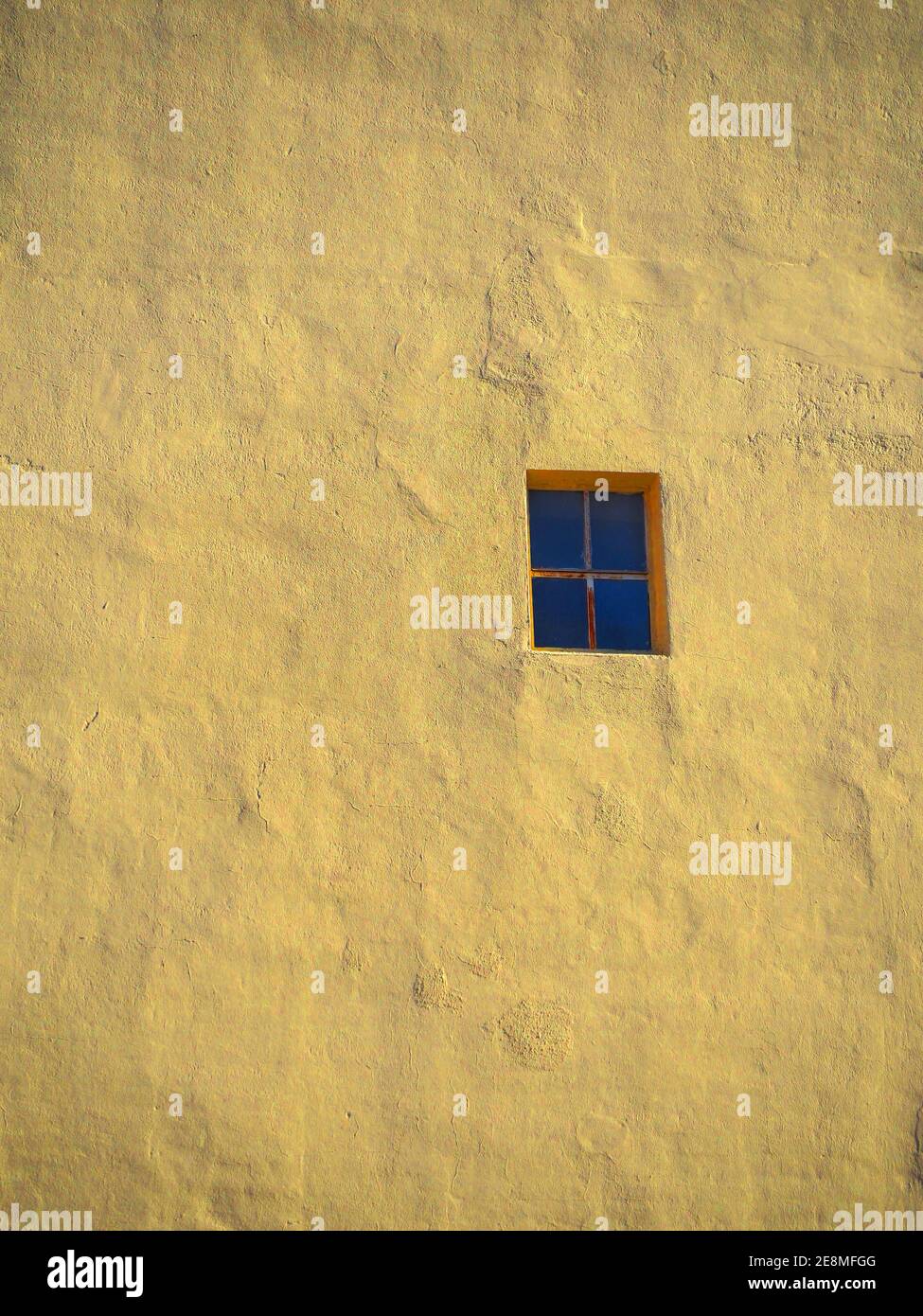 A single small window frame on the concrete wall - social isolation ...