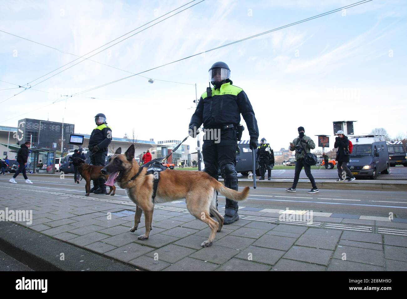 Dutch anti-riot police officers hold dogs advance to evacuate ...