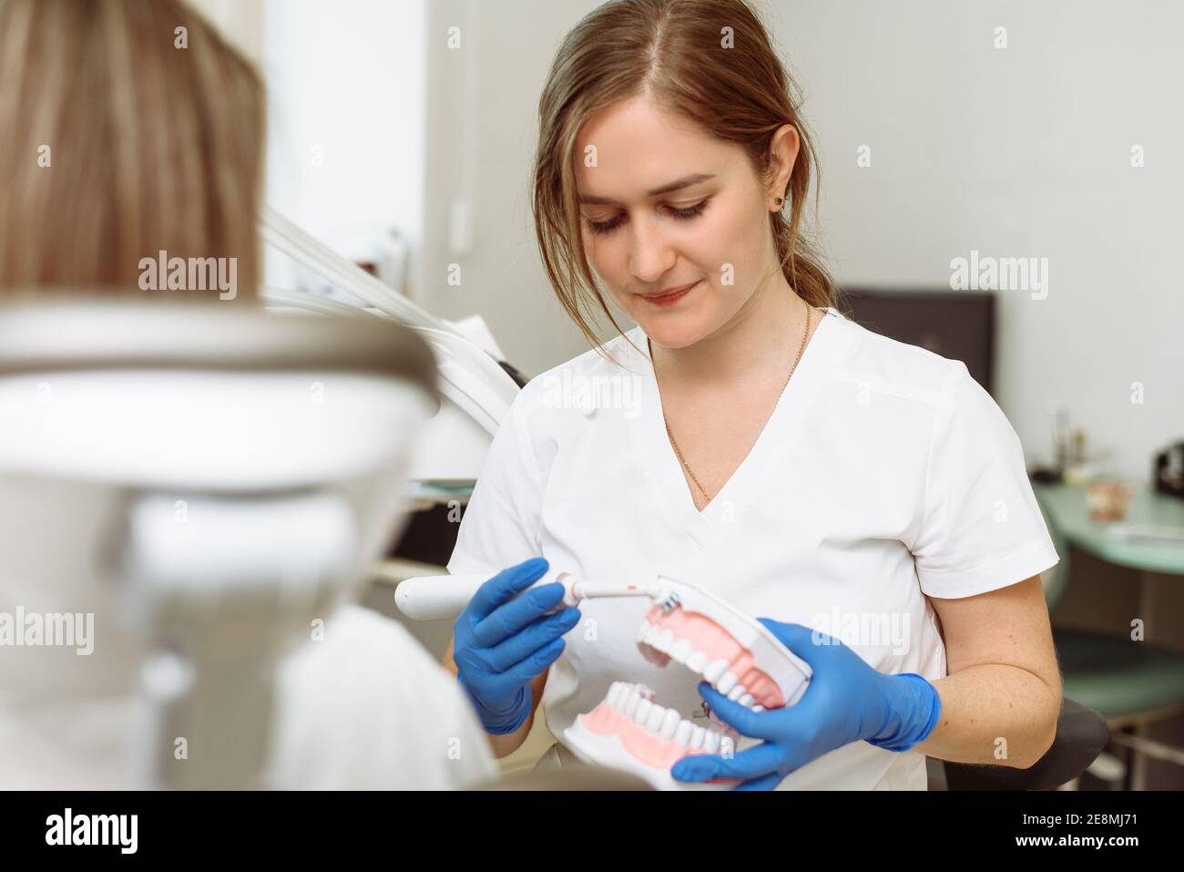 The doctor shows the patient how to properly brush his teeth with an ...
