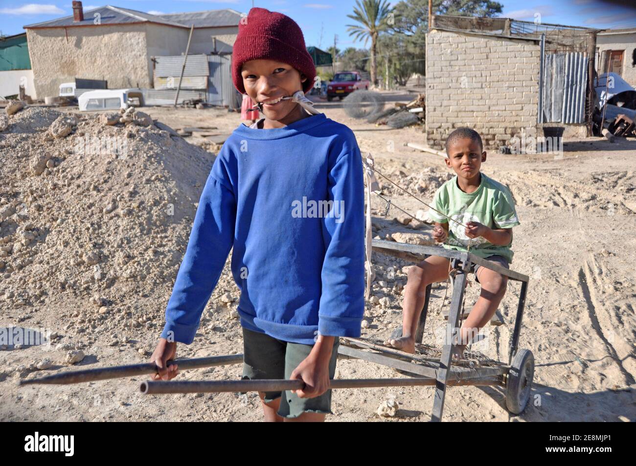 Someone has to play the dunky: Two namibian boys are playing a donkey ...