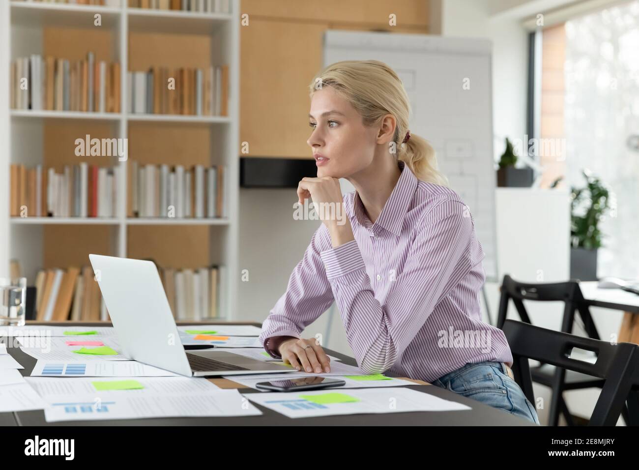 Pensive female project leader thinking over challenge Stock Photo - Alamy