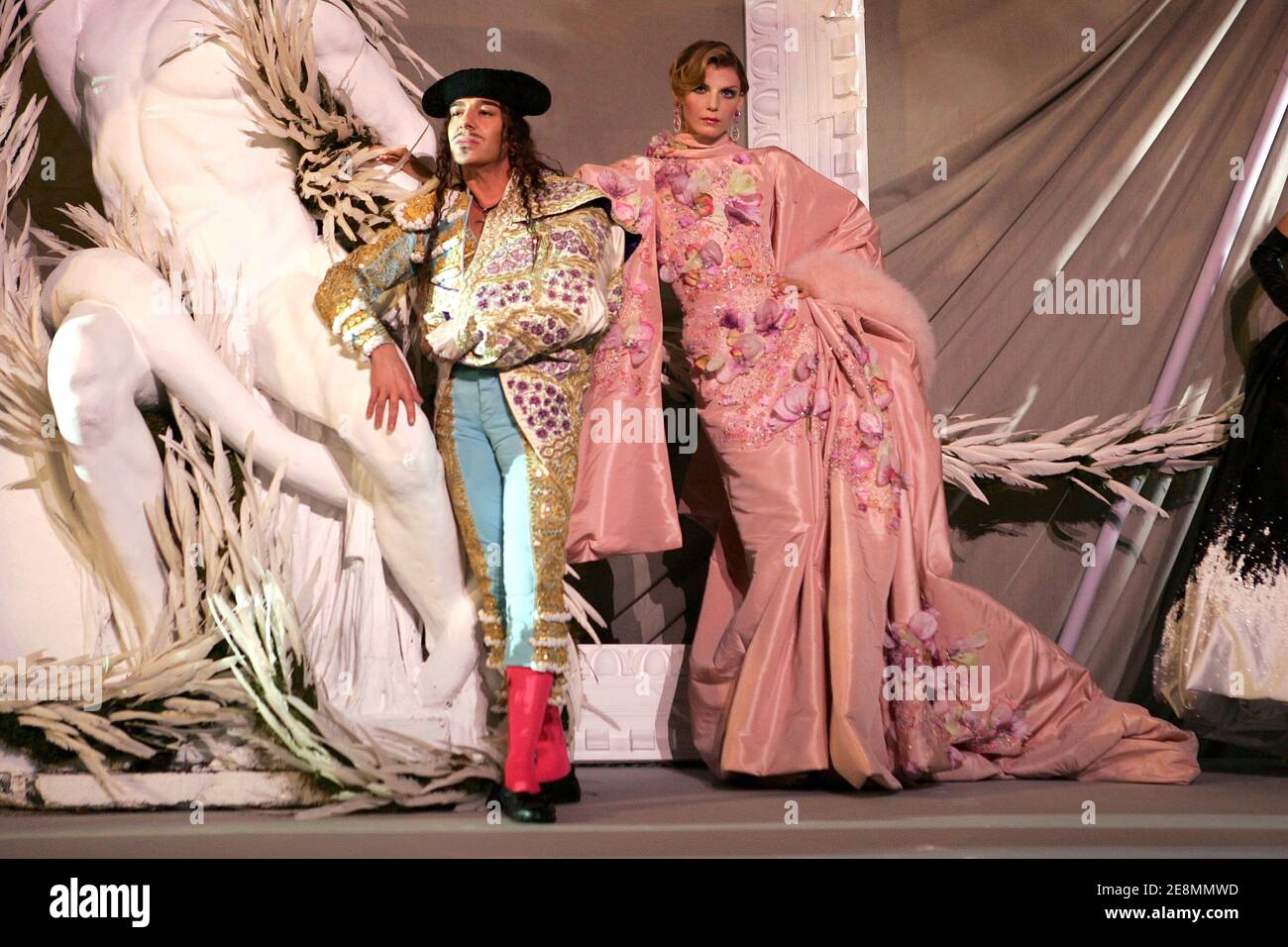 British designer John Galliano poses with a model at the end of ...