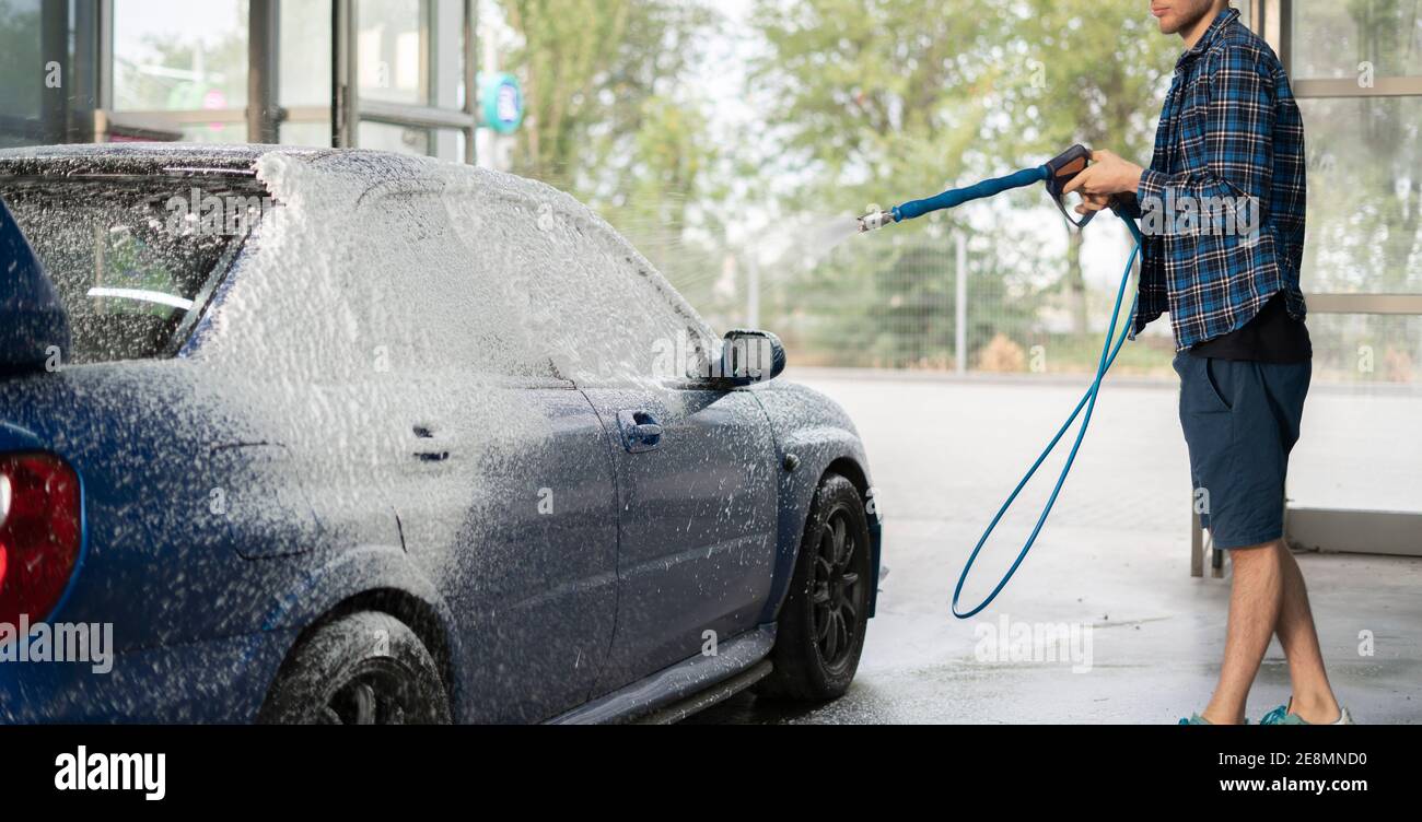 male driver cleaning the car inside the self wash station box Stock ...