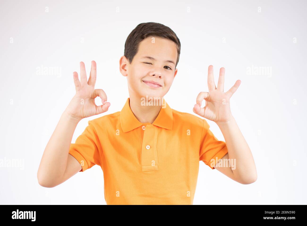 Boy showing okay gesture in sign language on white background Stock ...