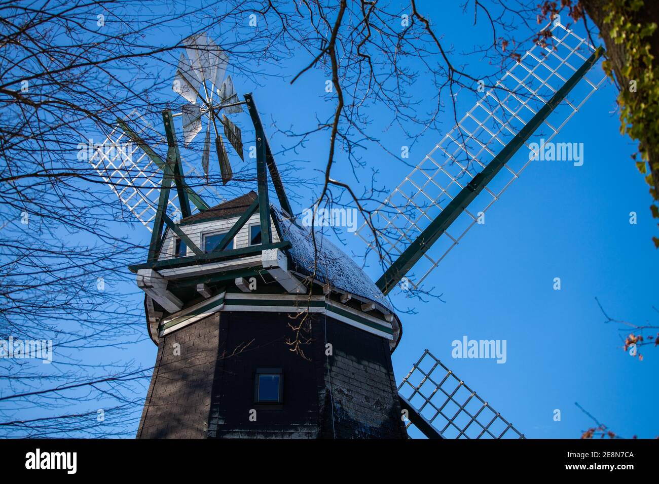 Windmill in snow covered landscape Stock Photo - Alamy