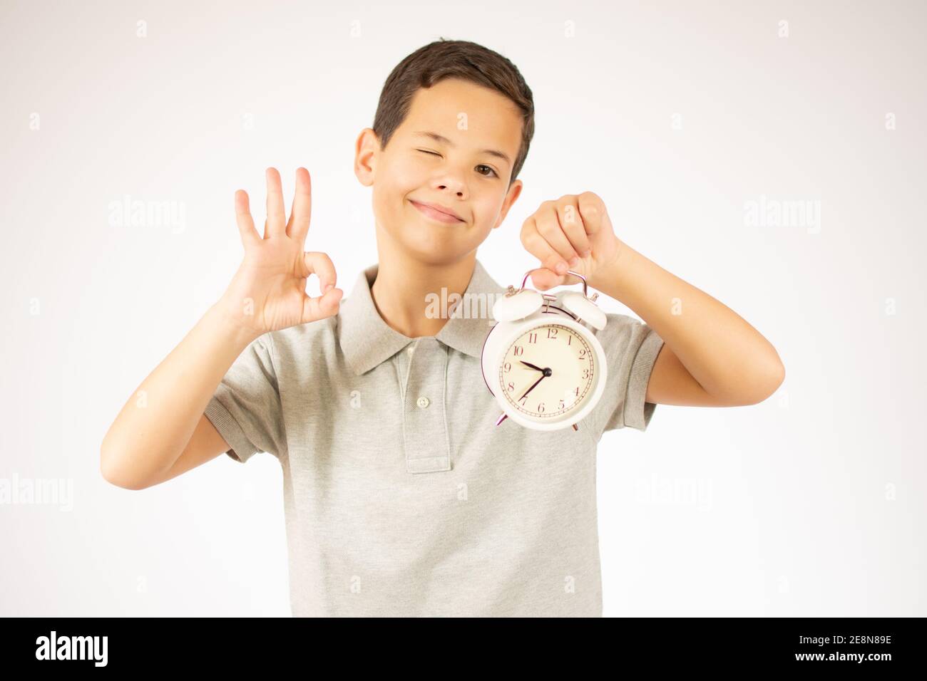 childhood, fashion and people concept - portrait of boy with alarm ...