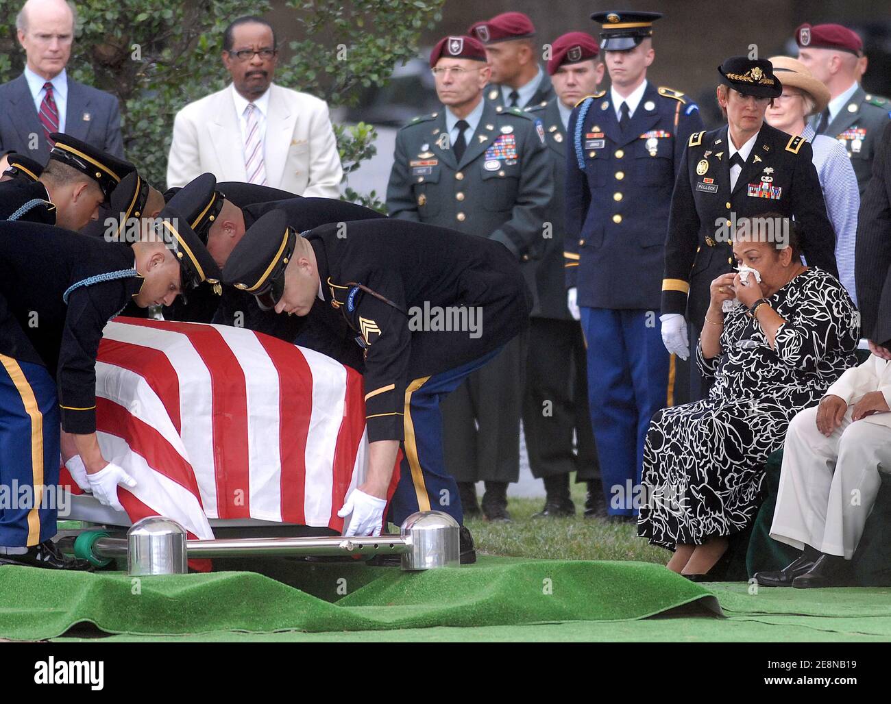 An honor guard prepares to fold a flag on the casket U.S. Army Captain ...