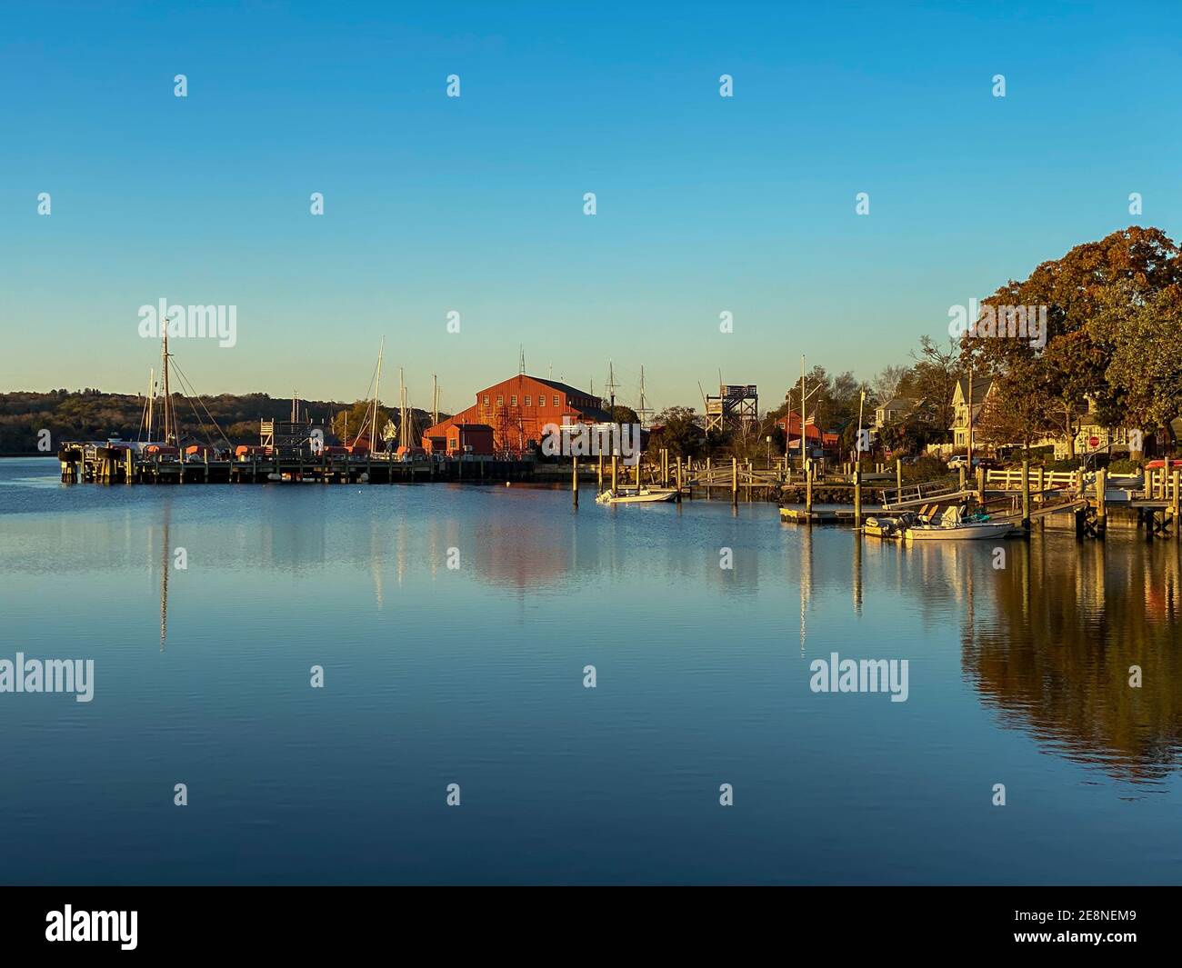 Sunset along the Mystic River in Mystic, Connecticut as reflections ...