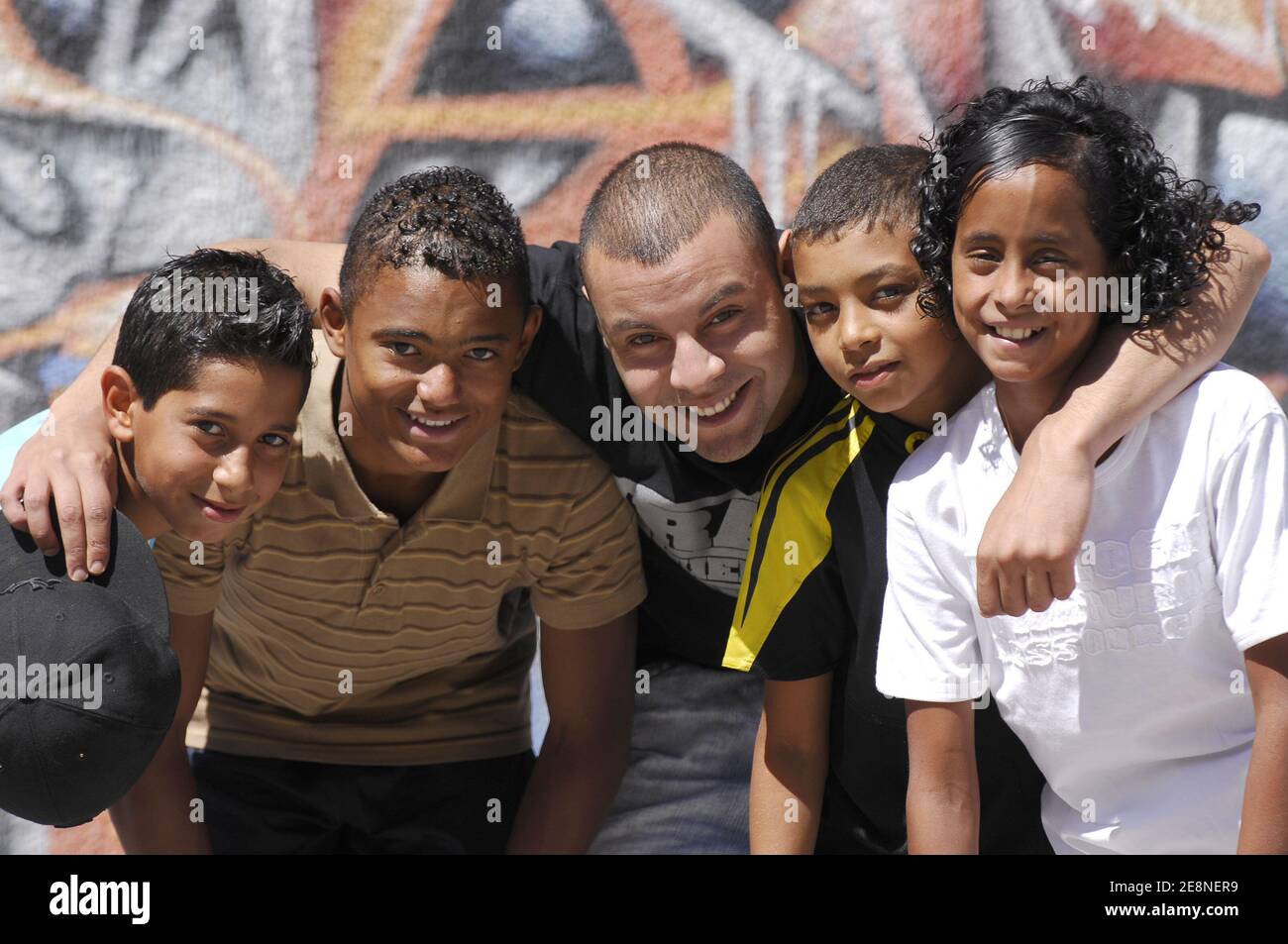 French rap singer El Matador poses with kids of his district in ...