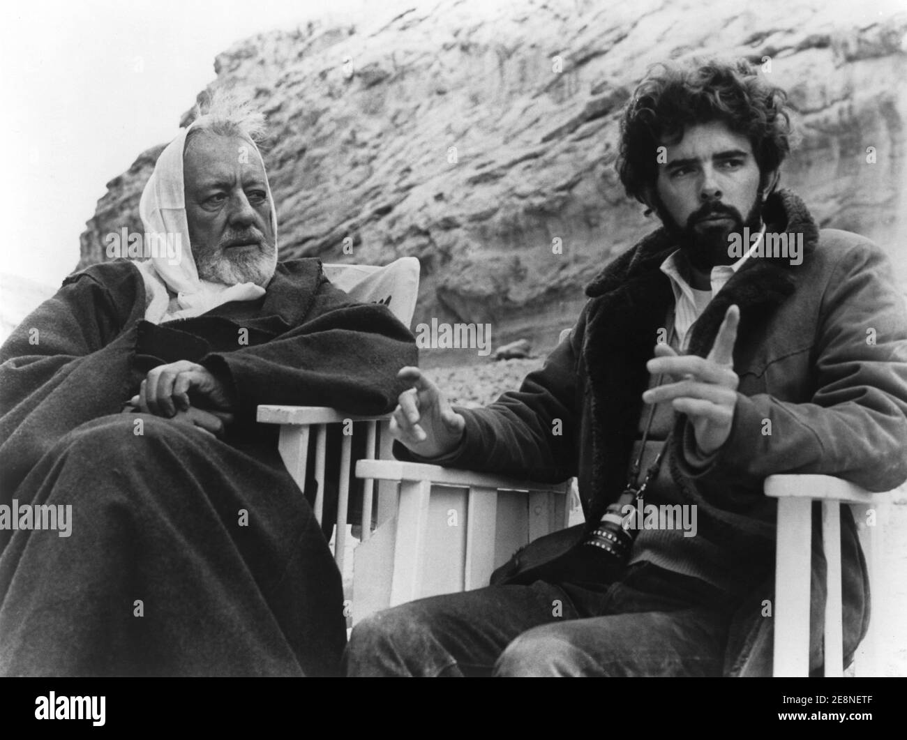 ALEC GUINNESS in costume as Ben Obi-Wan Kenobi and GEORGE LUCAS on set ...