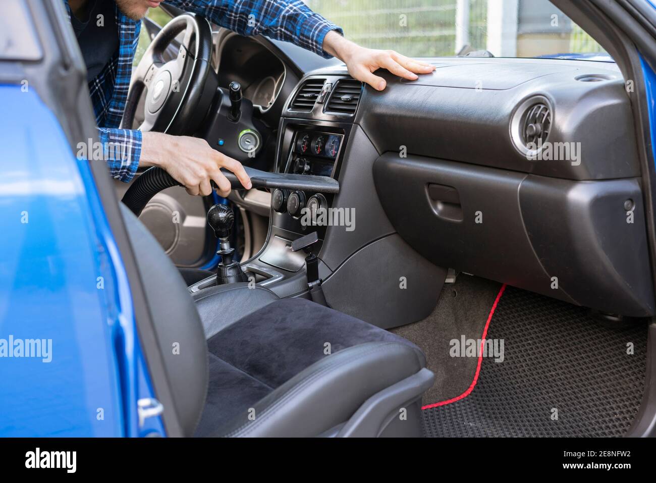 a male person cleaning the car interior with vacuum cleaner Stock Photo ...