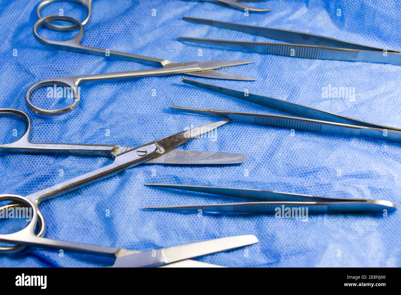 An isolated closeup of stainless steel dissection kit on blue medical ...