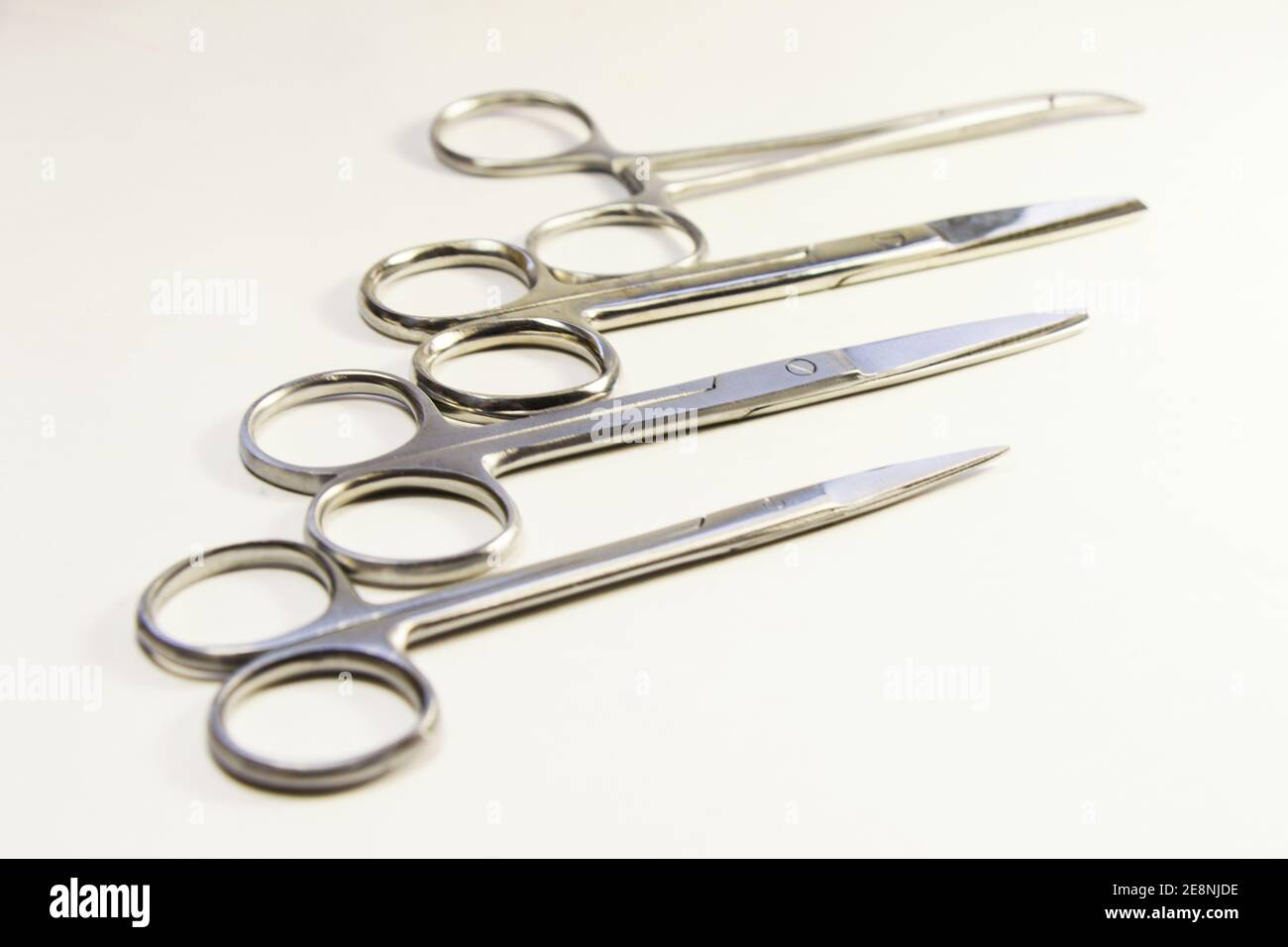 An isolated closeup of stainless steel dissection kit on white ...