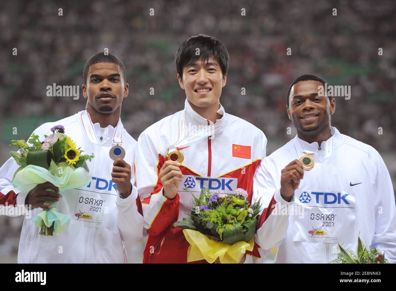 China's Liu Xiang poses with his gold medal, USA's Terence Trammell ...