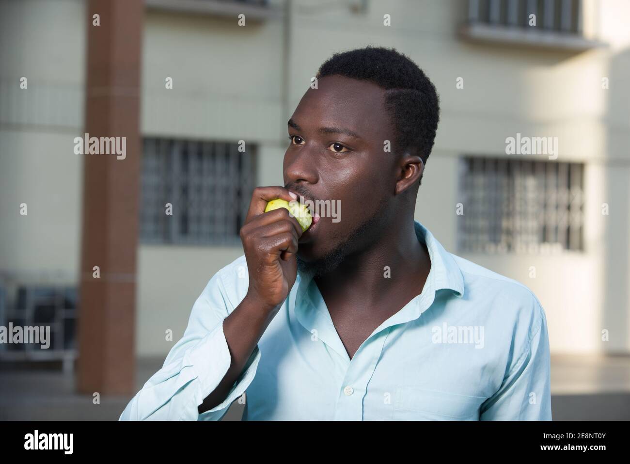 Young black man eating green hi-res stock photography and images - Alamy