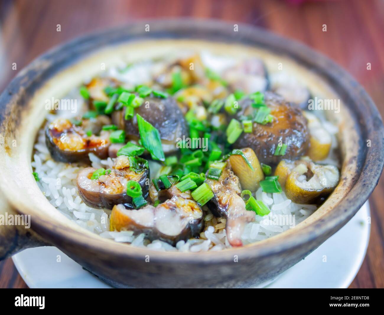 Close up shot of cooking the traditional eel fish claypot rice at Macau ...