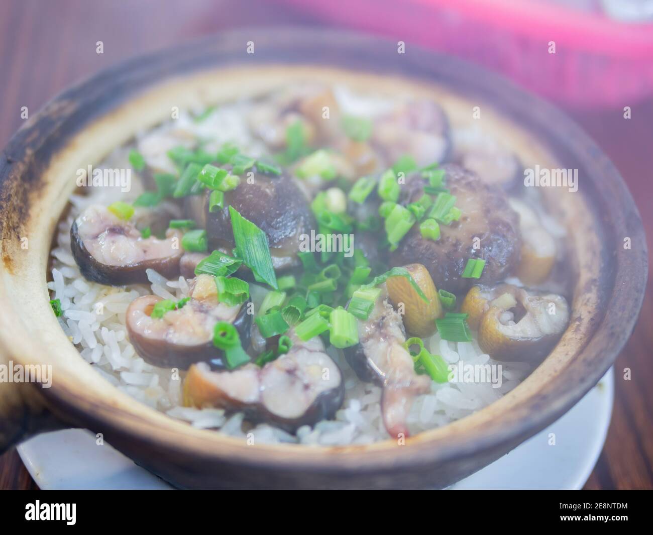 Close up shot of cooking the traditional eel fish claypot rice at Macau ...