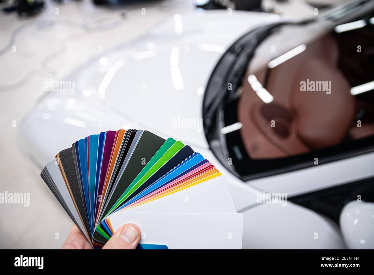 Man choosing color of his car with color sampler Stock Photo - Alamy