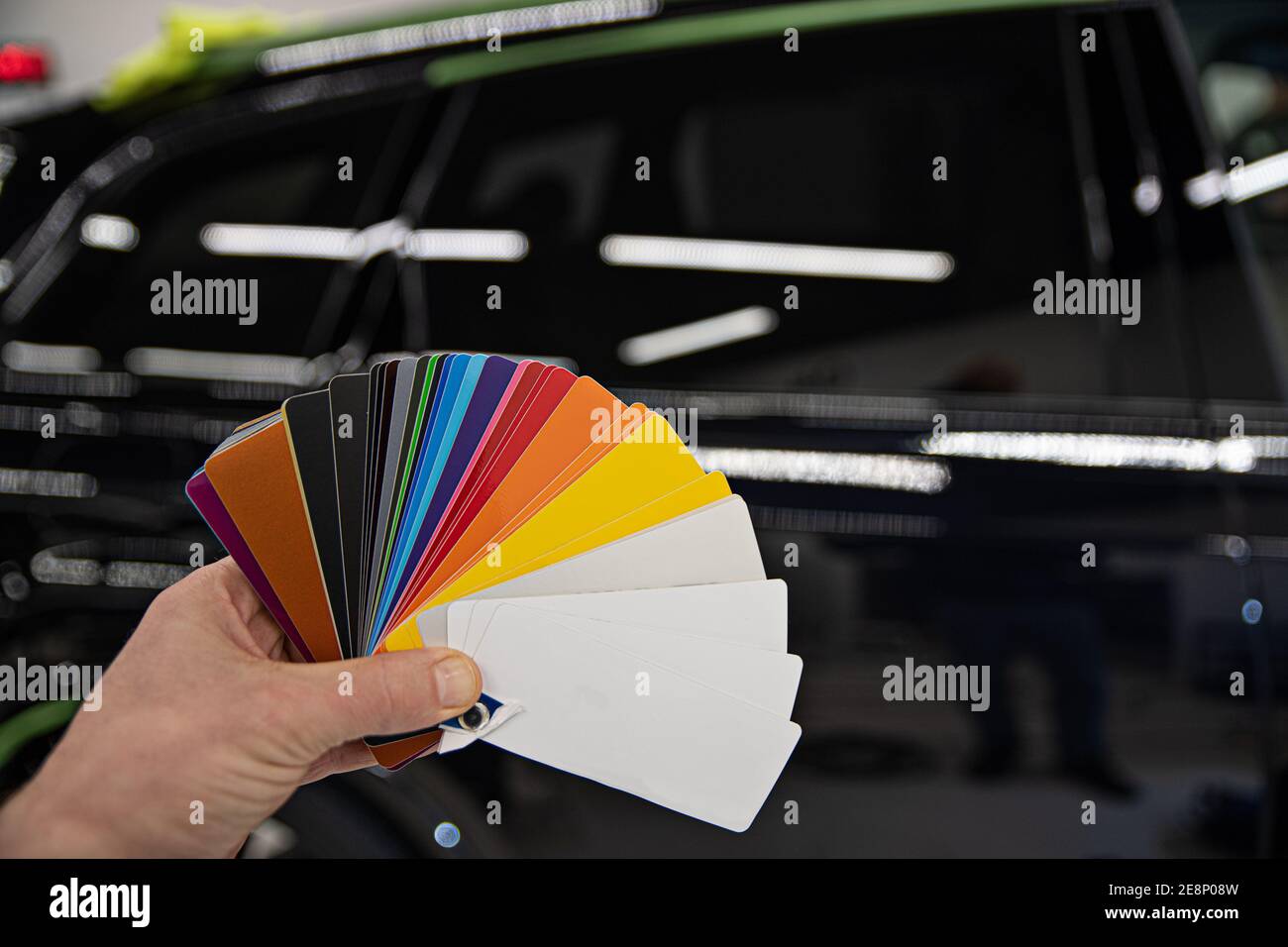 Man choosing color of his car with color sampler Stock Photo - Alamy