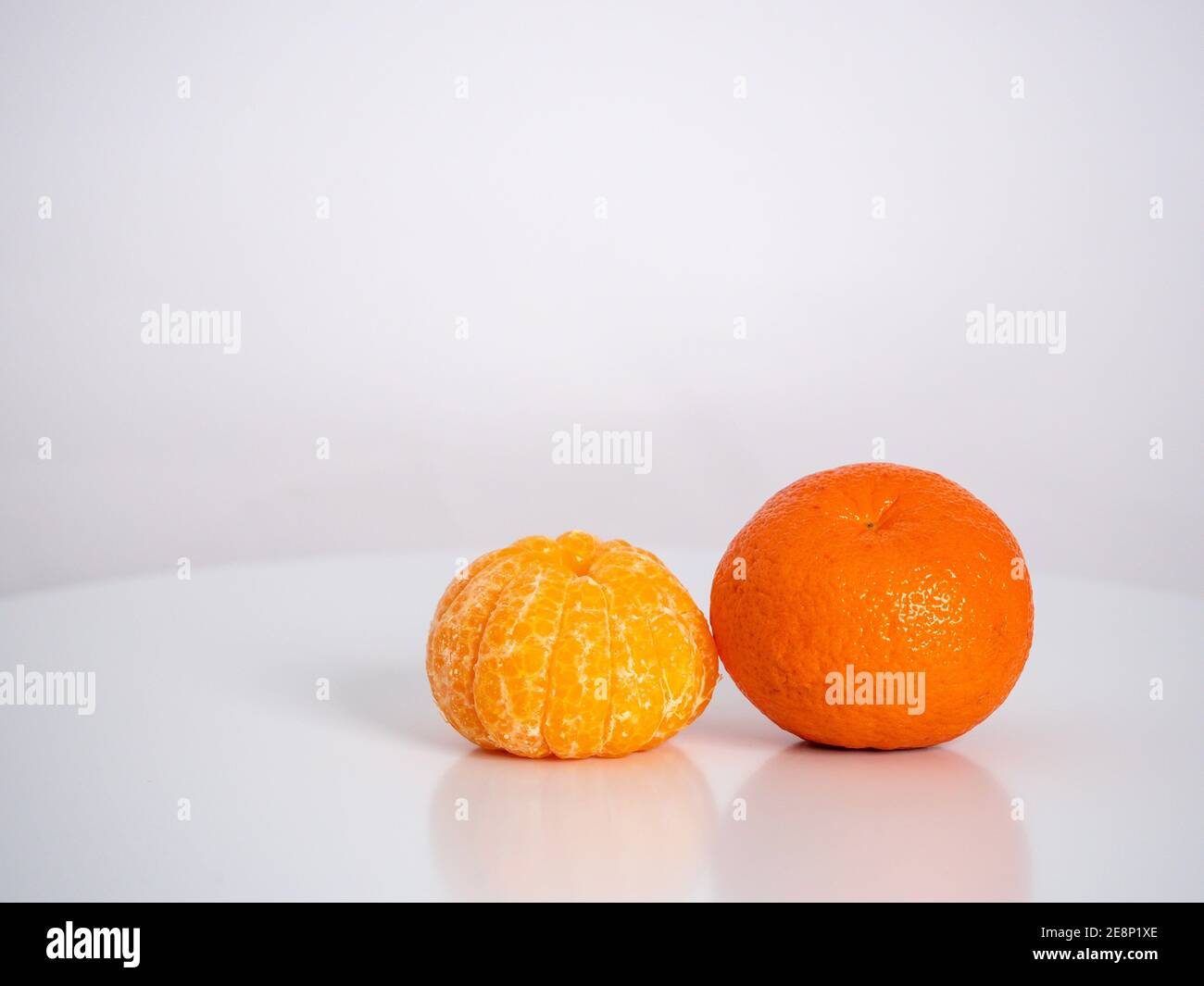 close up orange, peeled second mandarin on the skin Stock Photo - Alamy