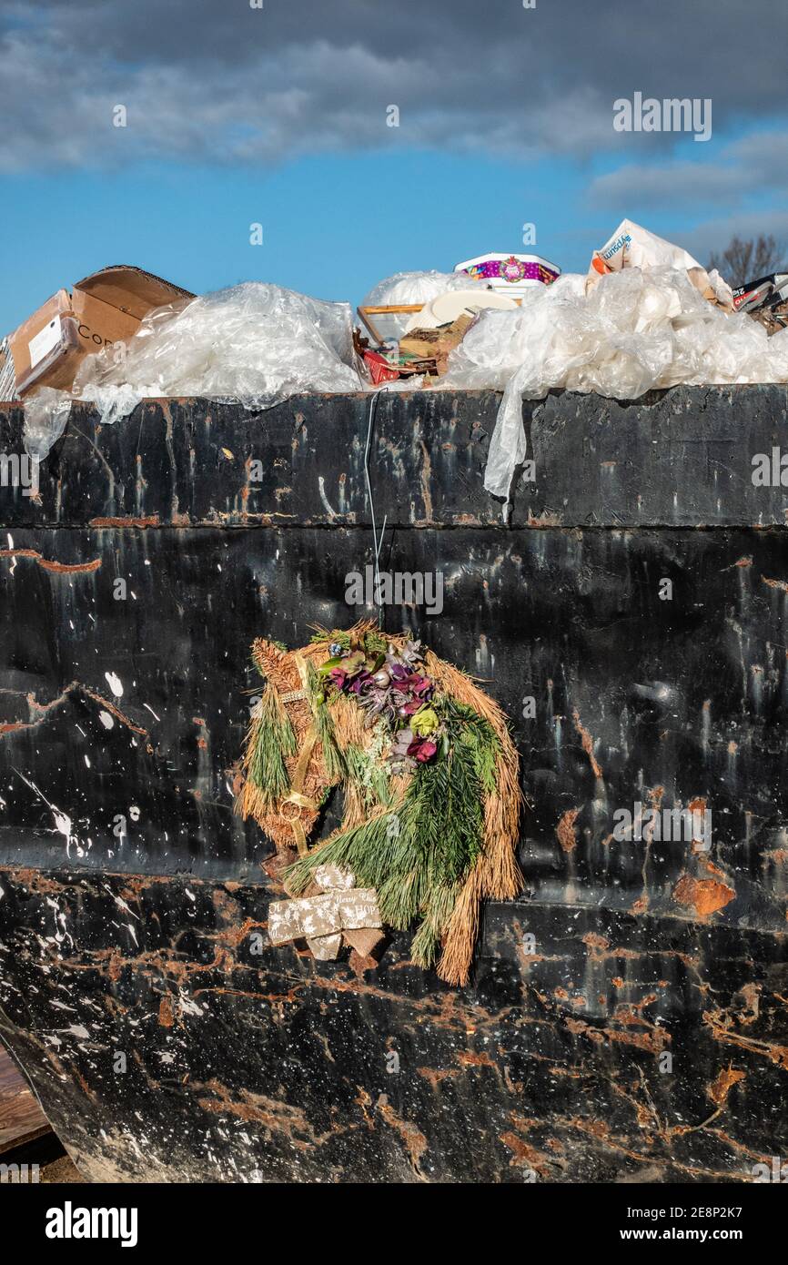 Old trashed Christmas decoration of a straw horses head stuck to a ...