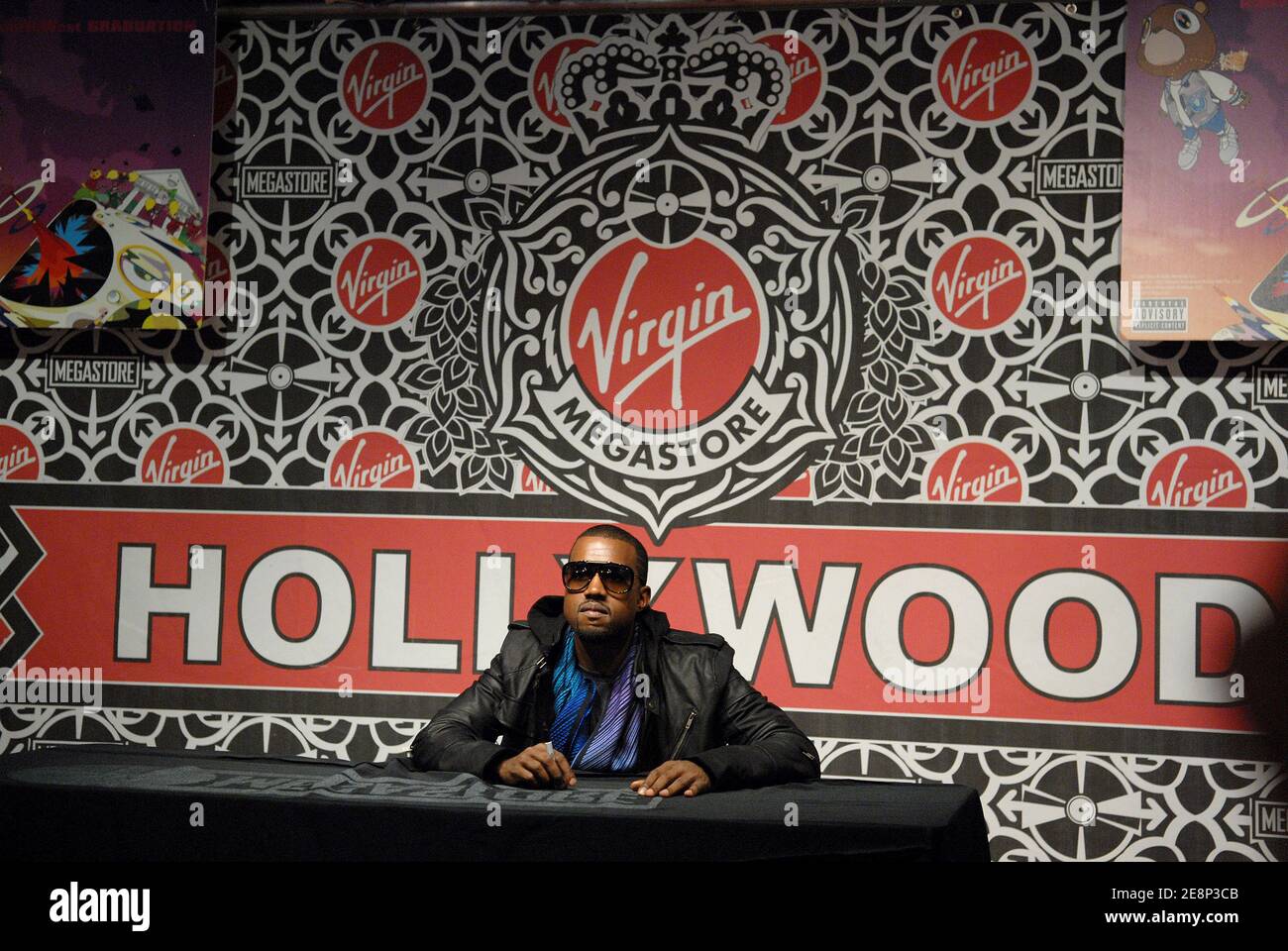 "Kanye West signs copies of his new release ""Graduation"" at the ...