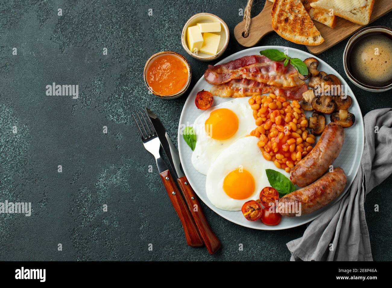 Full English breakfast on a plate with fried eggs, sausages, bacon ...
