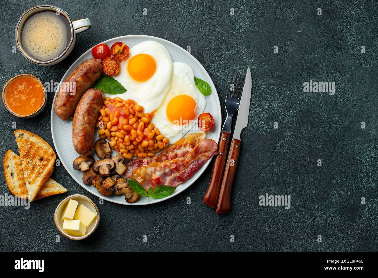 Full English breakfast on a plate with fried eggs, sausages, bacon ...