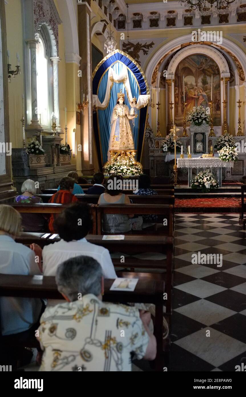 Bari, Italy - July 08, 2013: faithful in prayer front of a statue of ...