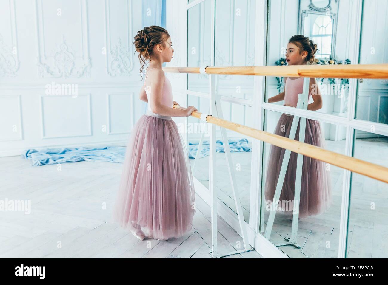 Young classical ballet dancer girl in dance class. Beautiful graceful ...