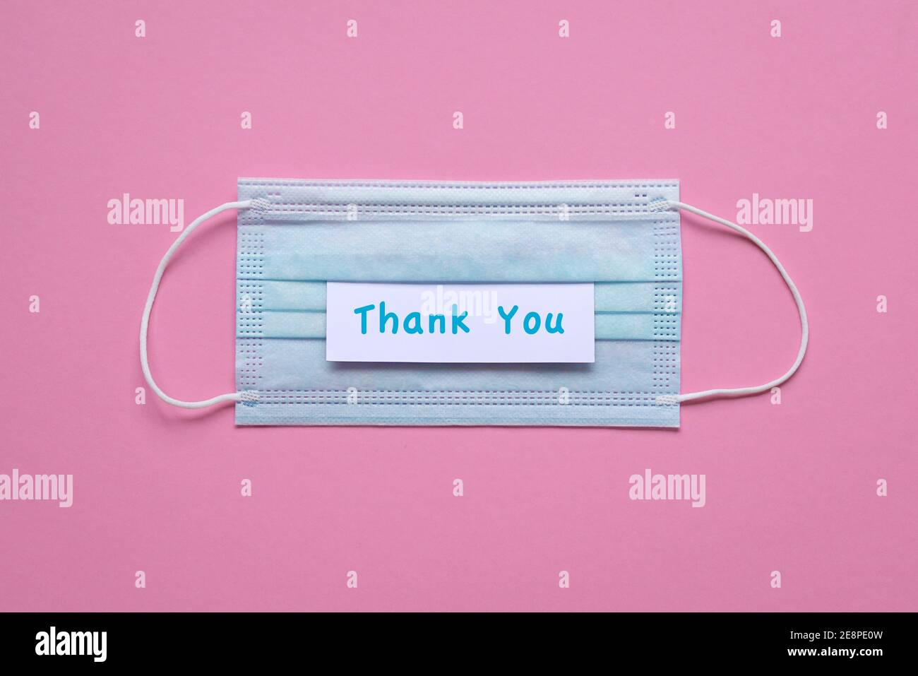 Thank you note on top of medical face mask. Top view. Appreciation to ...