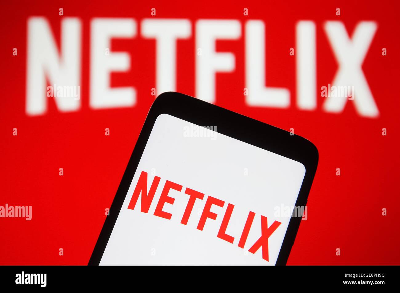 In this photo illustration the Netflix logo seen displayed on a mobile ...