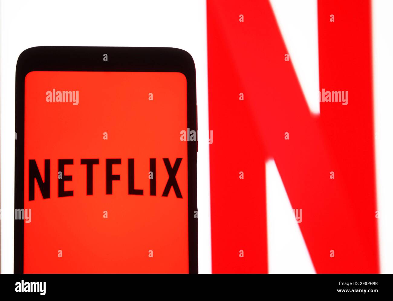 In this photo illustration the Netflix logo seen displayed on a mobile ...