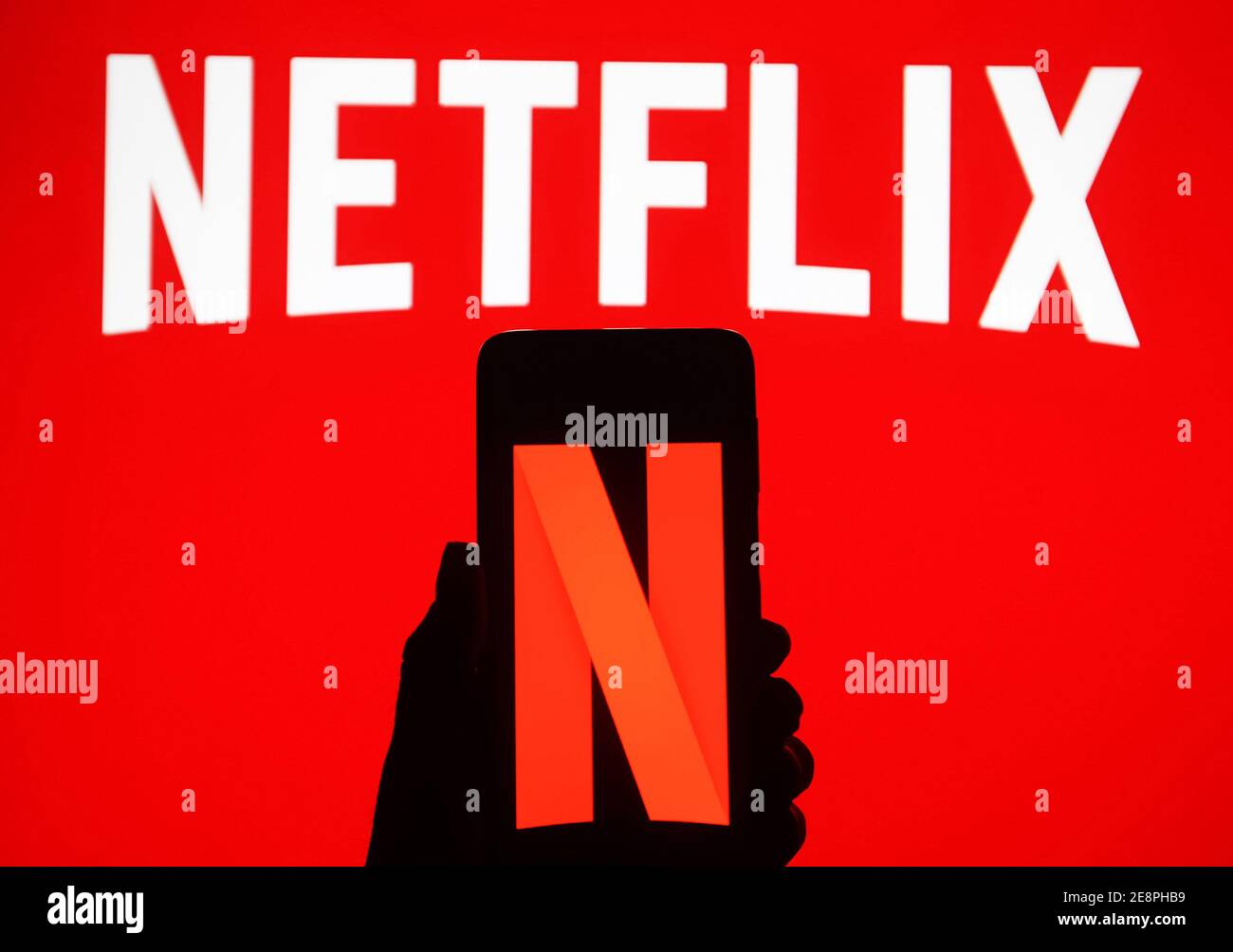 In this photo illustration the Netflix logo seen displayed on a mobile ...