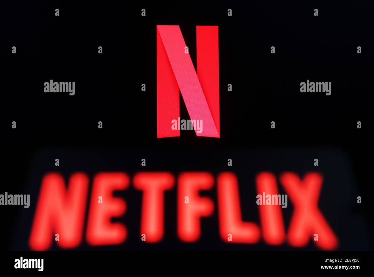 In this photo illustration the Netflix logo seen displayed on a mobile ...