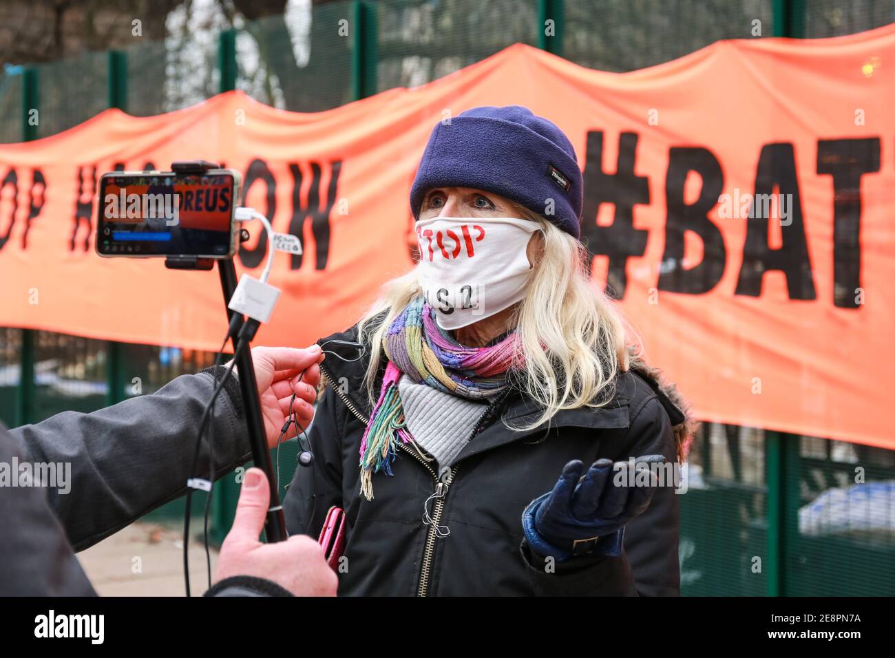 London, UK. 31 Jan 2021. An activist from HS2 Rebellion wears a "Stop ...