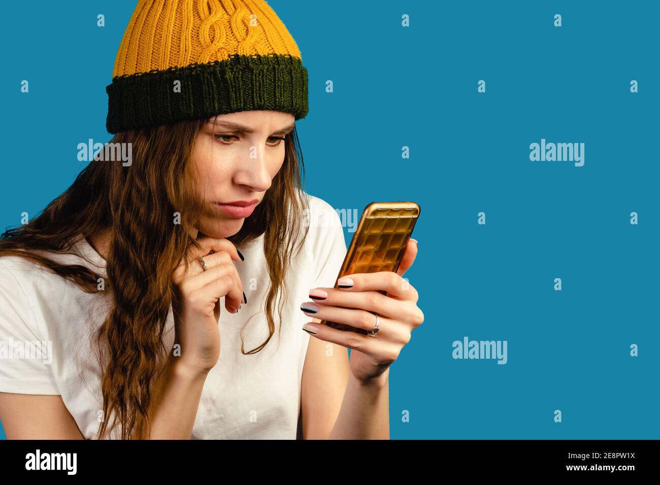 Woman doing Video Call using a phone isolated on blue background ...