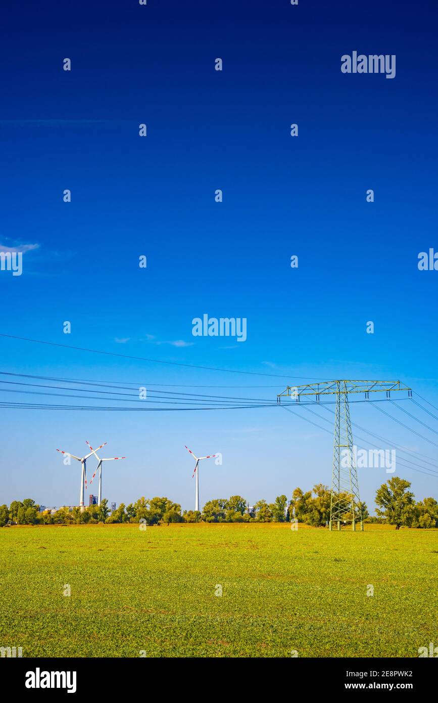 Beautiful green farm landscape with wind turbines to generate ...