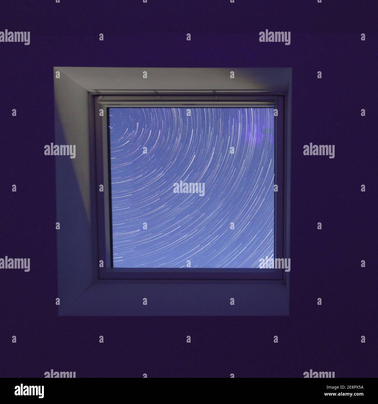 looking into night sky outside through window with star trails circular ...
