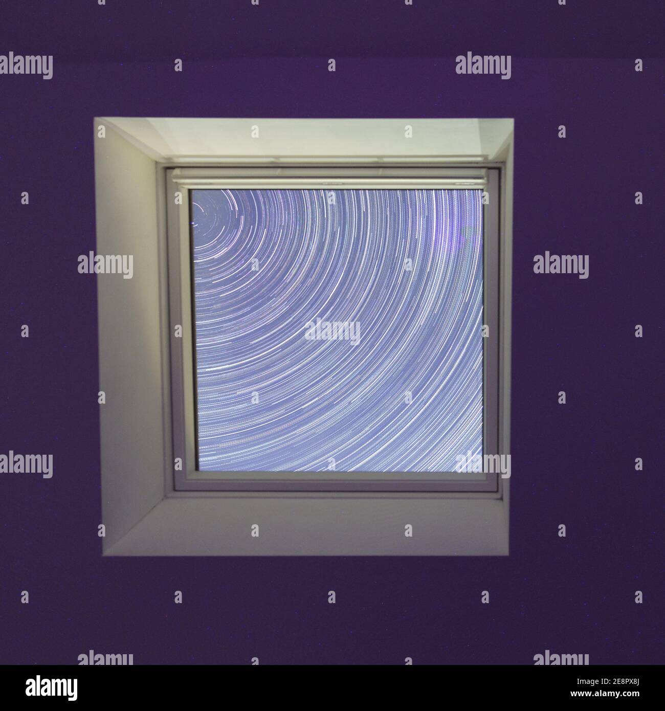 looking into night sky outside through window with star trails circular ...