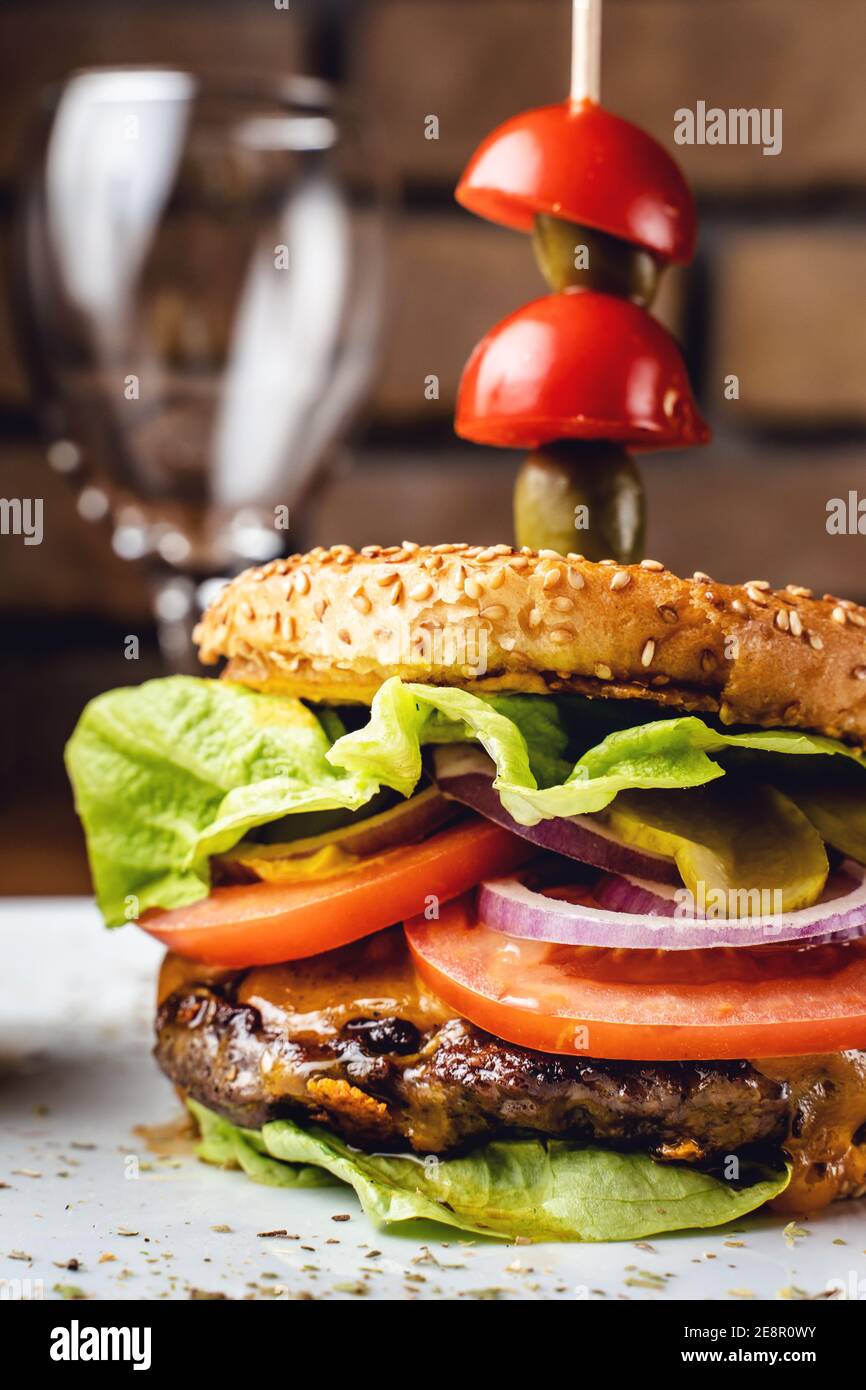 Burger with beef tomato onion and lettuce leaves on a plate served at ...