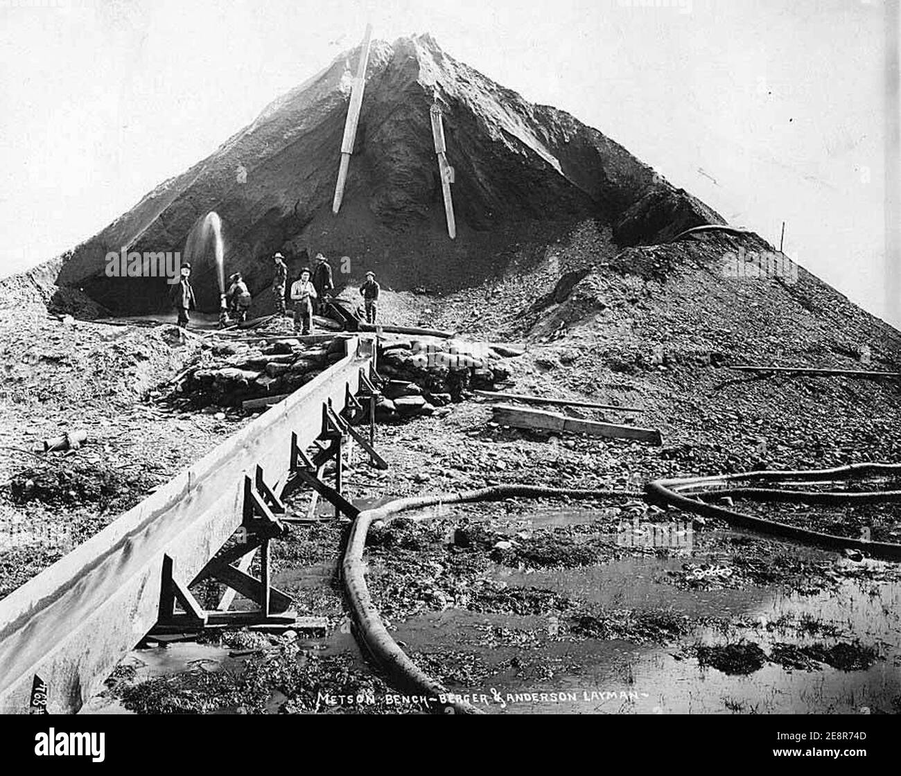 Mining operation showing men working with a sluice and hydraulic ...