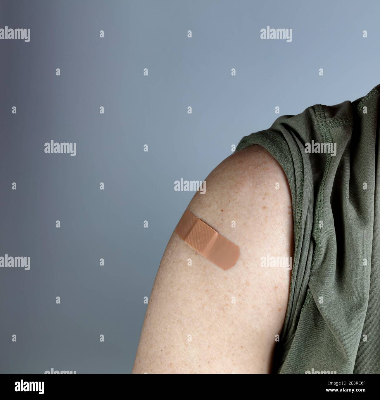 Band aid on male upper arm after coronavirus vaccine shot Stock Photo ...