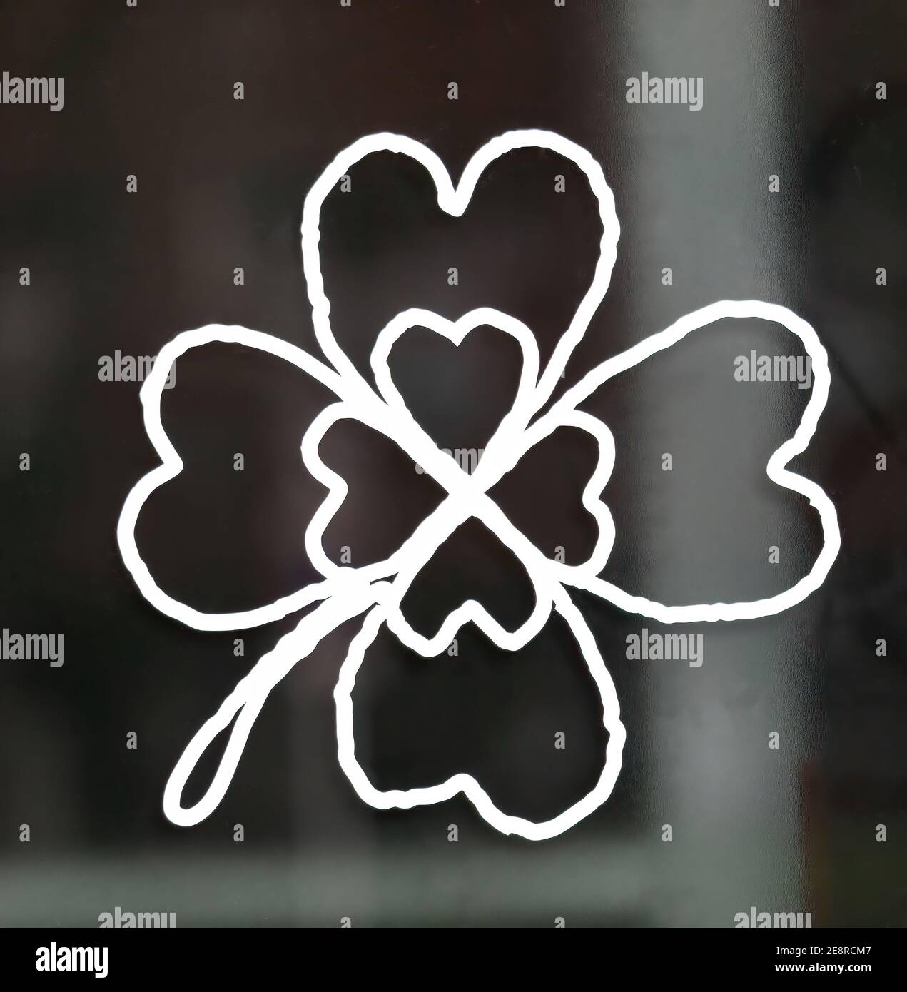 Clover sticker, in white, on a glass window Stock Photo - Alamy